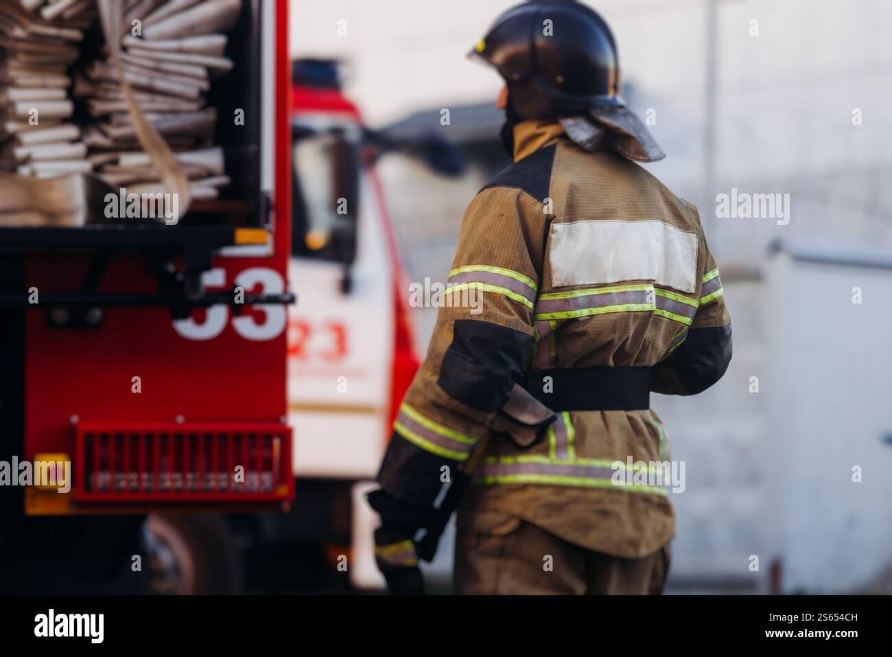 Group of fire men in uniform during fire fighting operation in the city ...