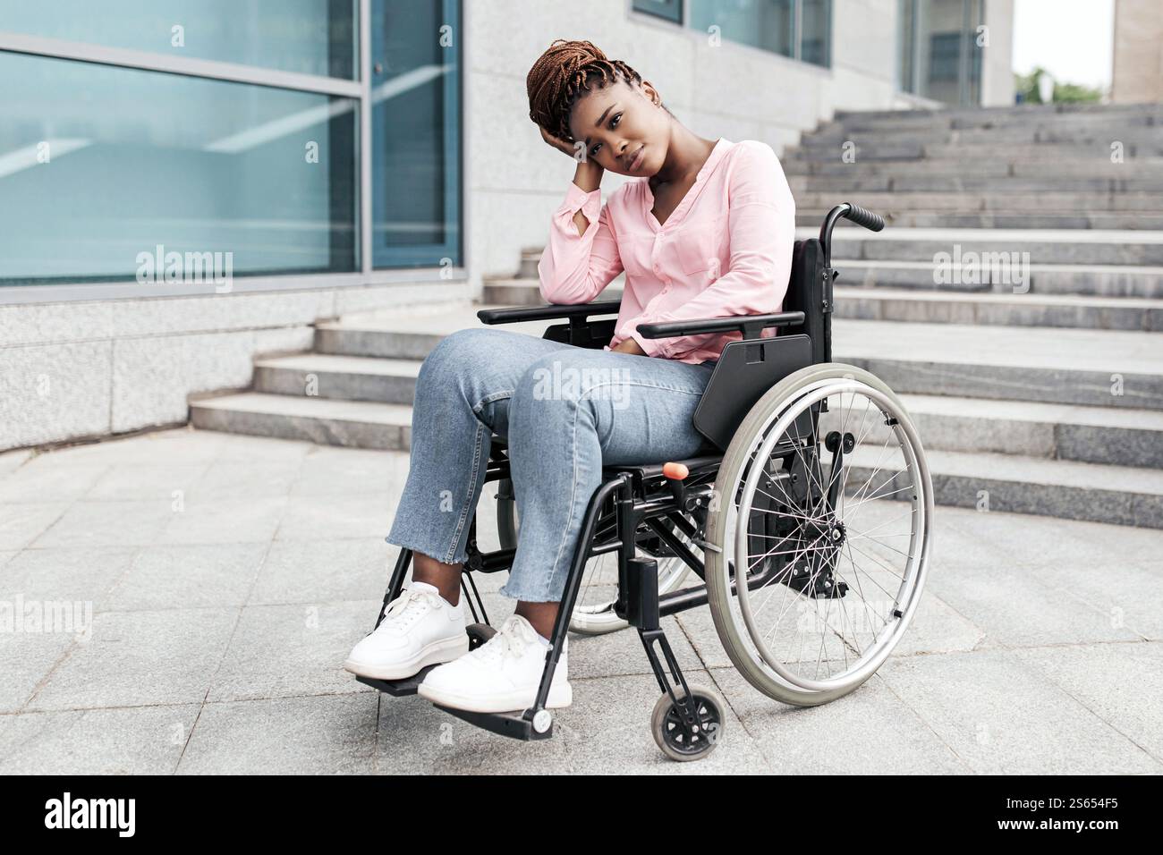Upset young black lady suffering from lack of wheelchair friendly ...