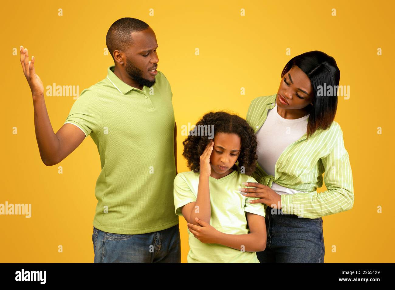 Young black father shouting at daughter and mother comforting upset ...