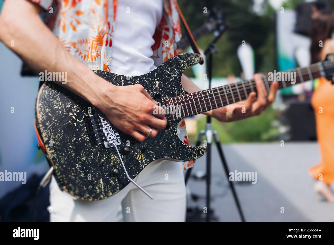 Concert view of electric guitar player with a vocalist and rock band ...