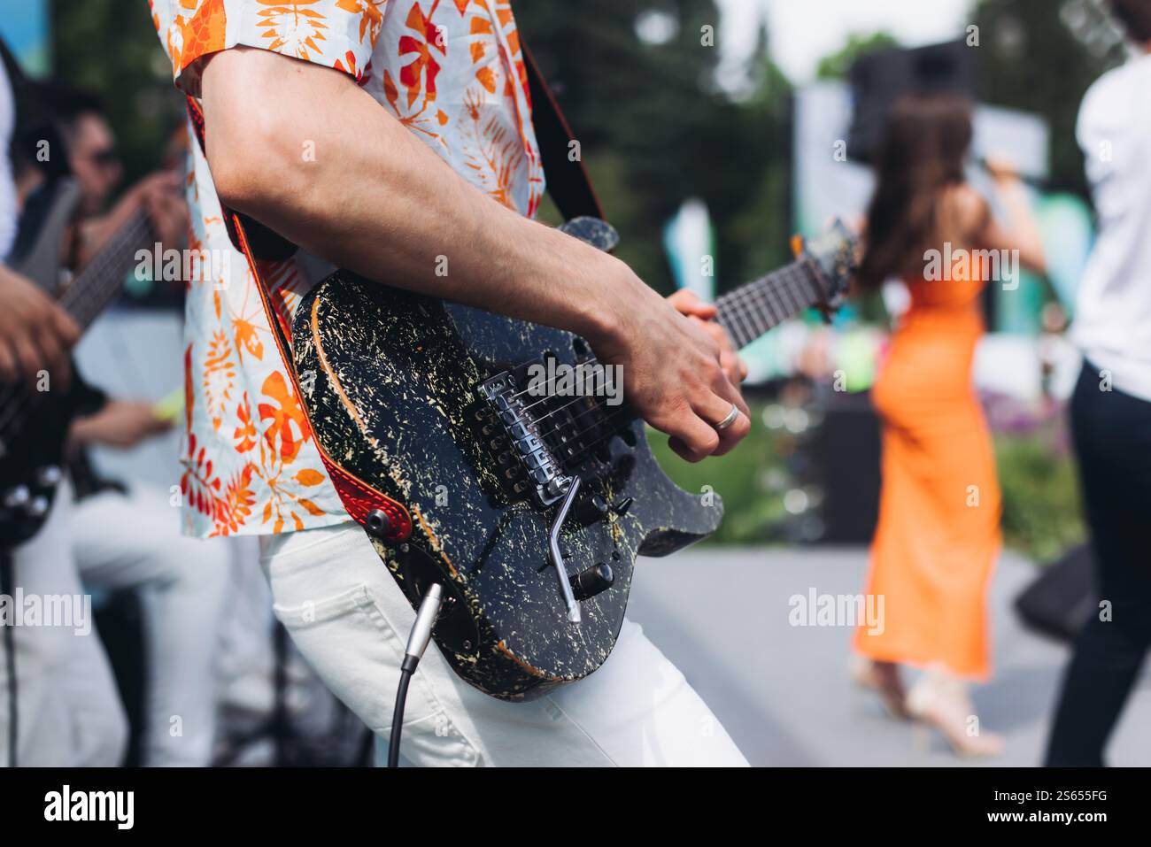 Concert view of electric guitar player with a vocalist and rock band ...