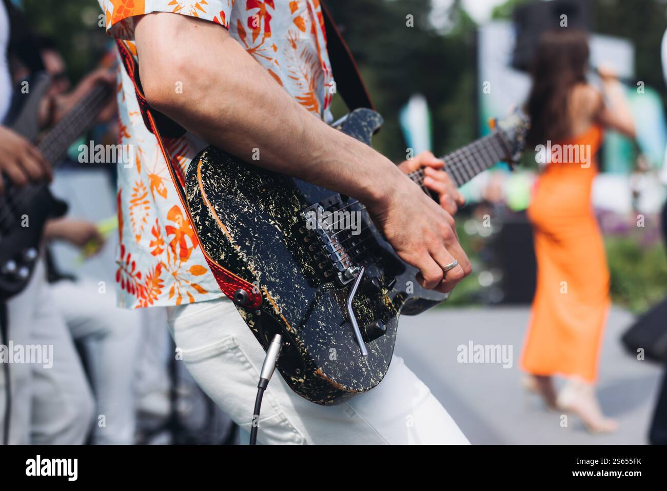 Concert view of electric guitar player with a vocalist and rock band ...