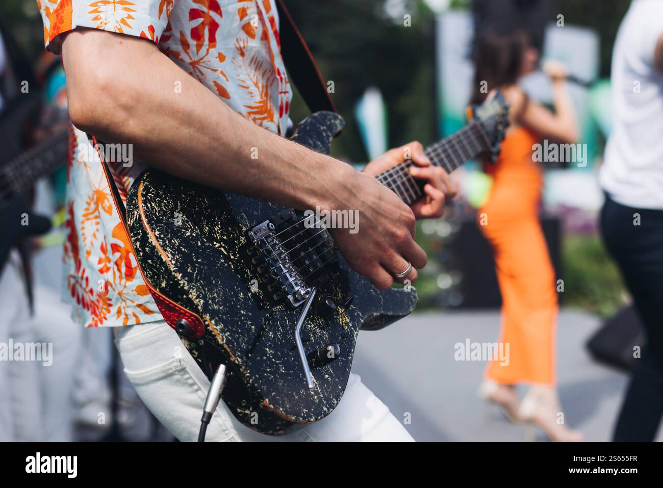 Concert view of electric guitar player with a vocalist and rock band ...