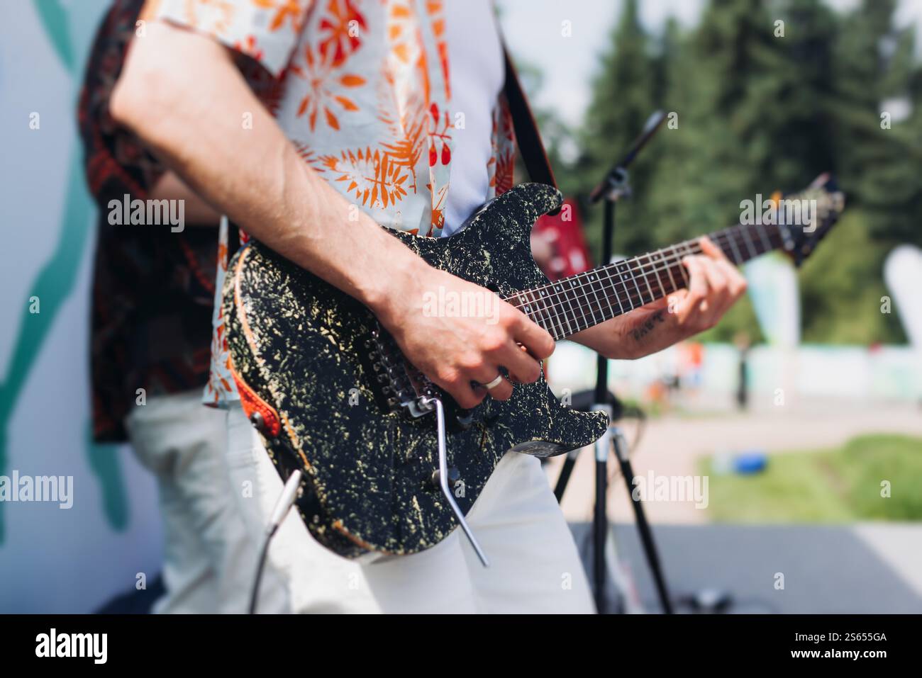 Concert view of electric guitar player with a vocalist and rock band ...