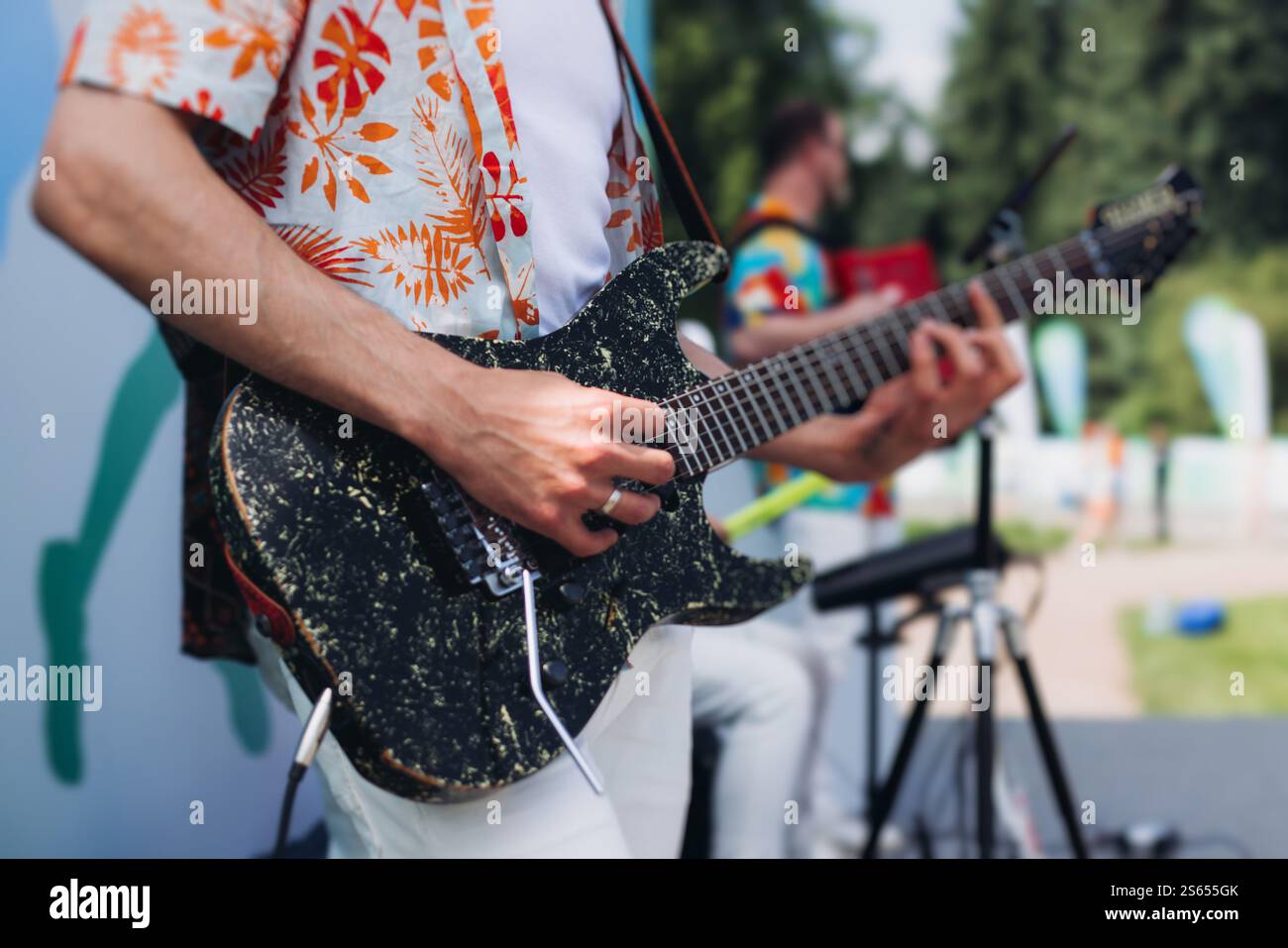 Concert view of electric guitar player with a vocalist and rock band ...