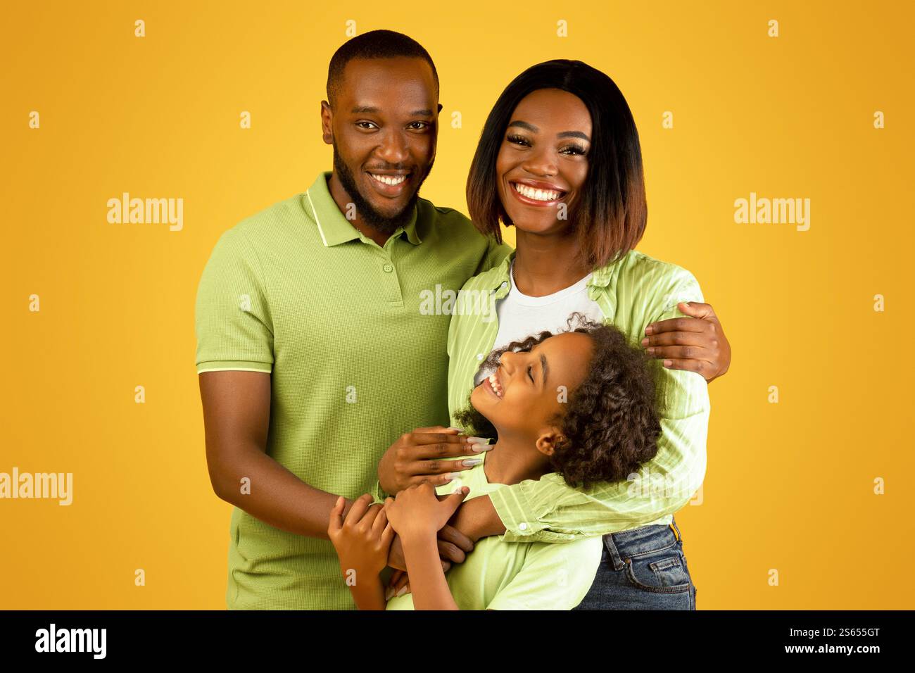 Happy family. Loving african american parents with daughter embracing ...