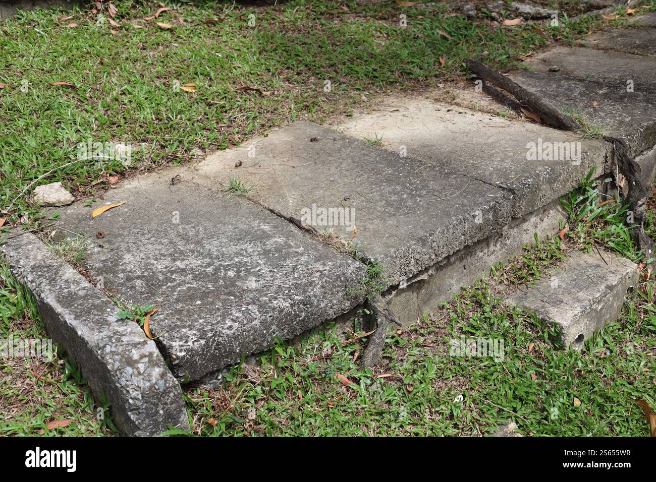 concrete slabs covering narrow drainage ditch Stock Photo - Alamy