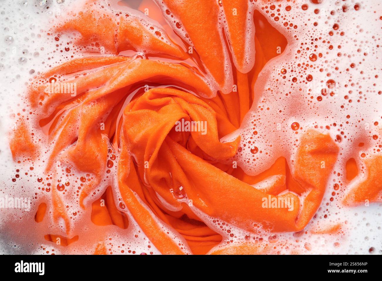 Orange clothes soaked in water before washing, top view Stock Photo - Alamy