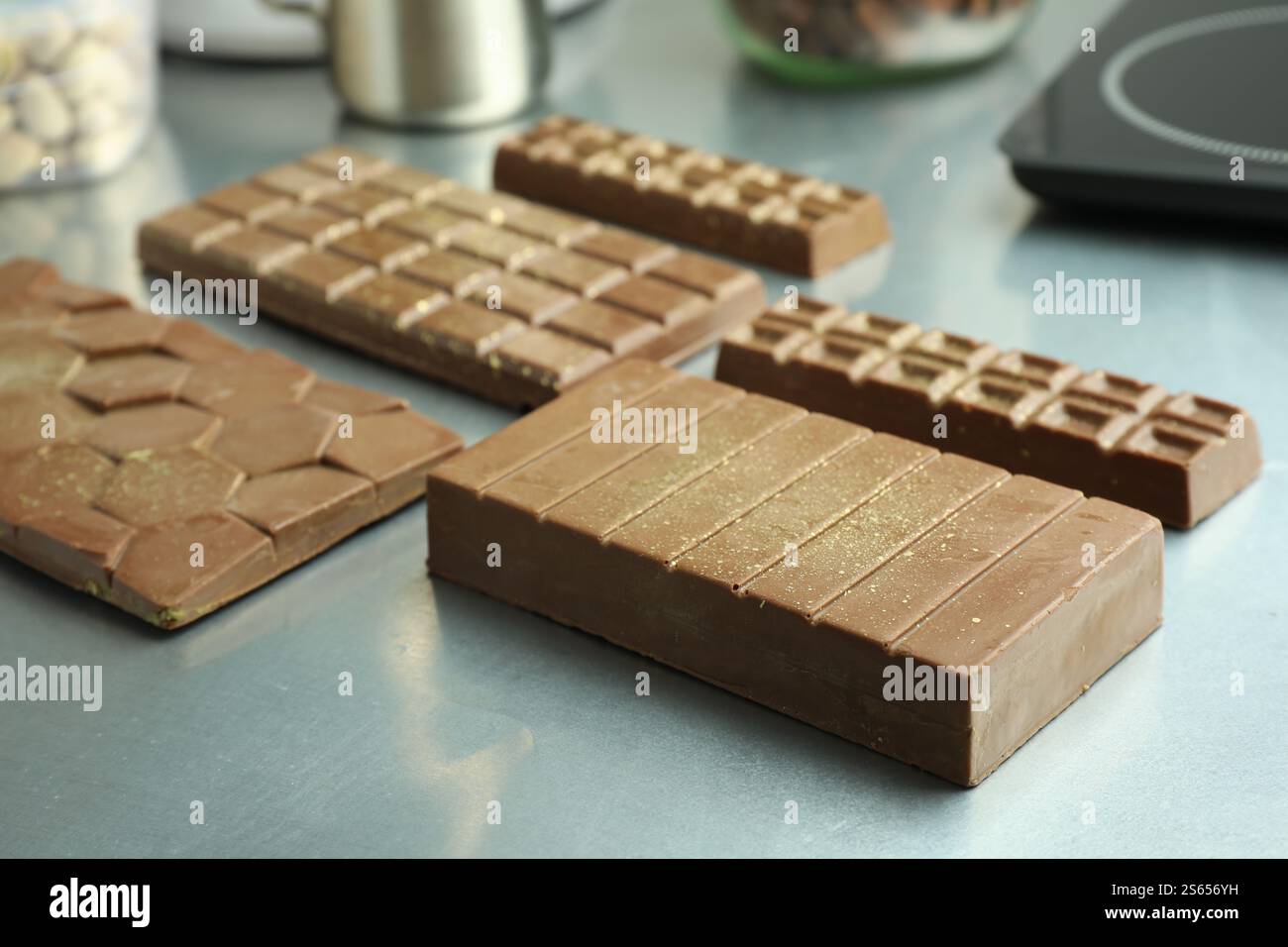 Different tasty Dubai chocolate bars with pistachios and knafeh on grey ...