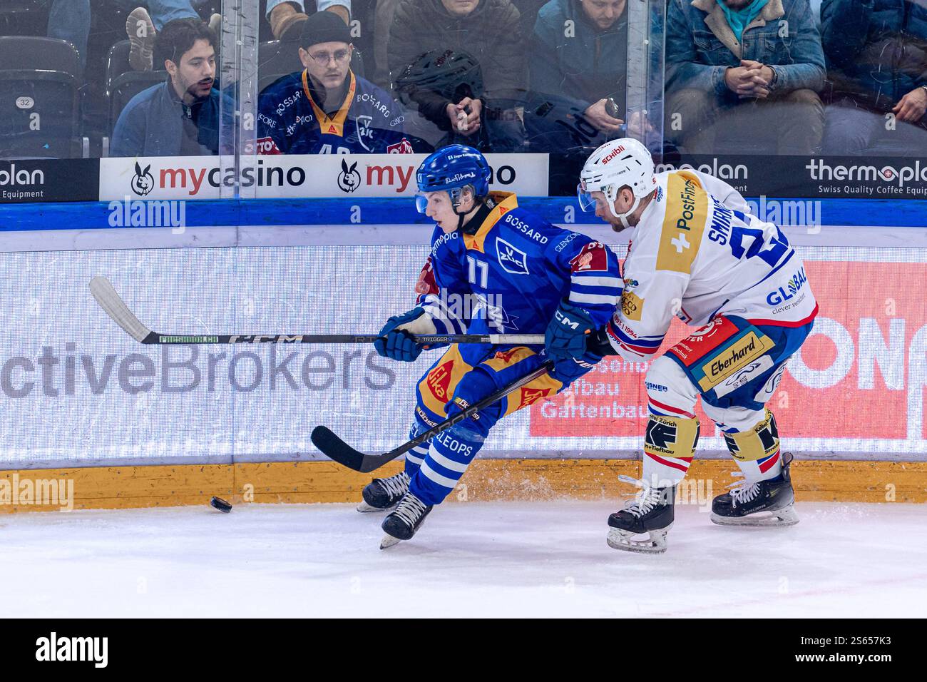 Deniss Smirnovs #27 (EHC Kloten) works on Loris Wey #77 (EV Zug) - 15. ...