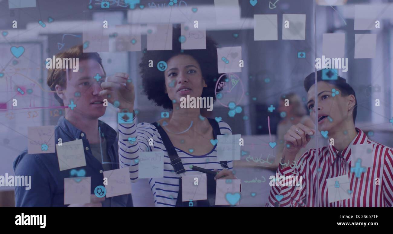 Image of network of connections with icons over diverse colleagues ...