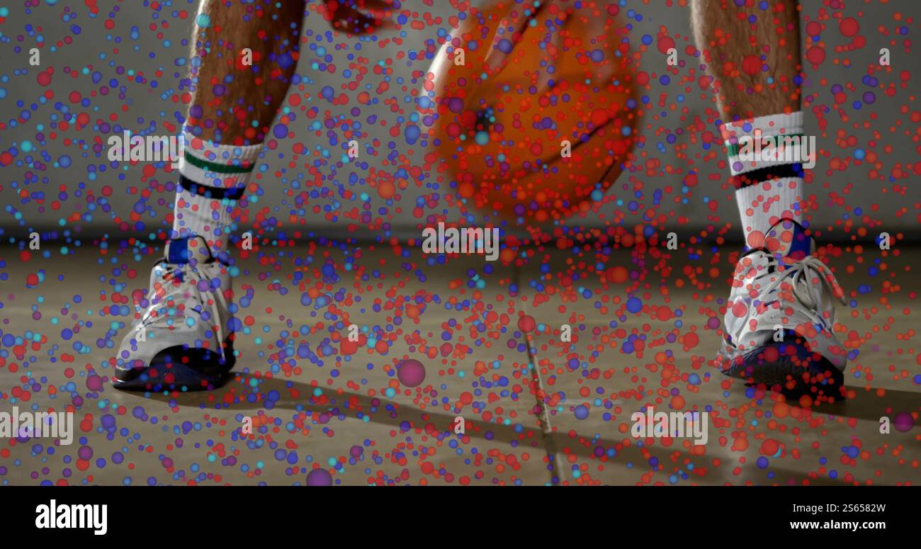 Dribbling basketball, person with spots image over legs Stock Photo - Alamy
