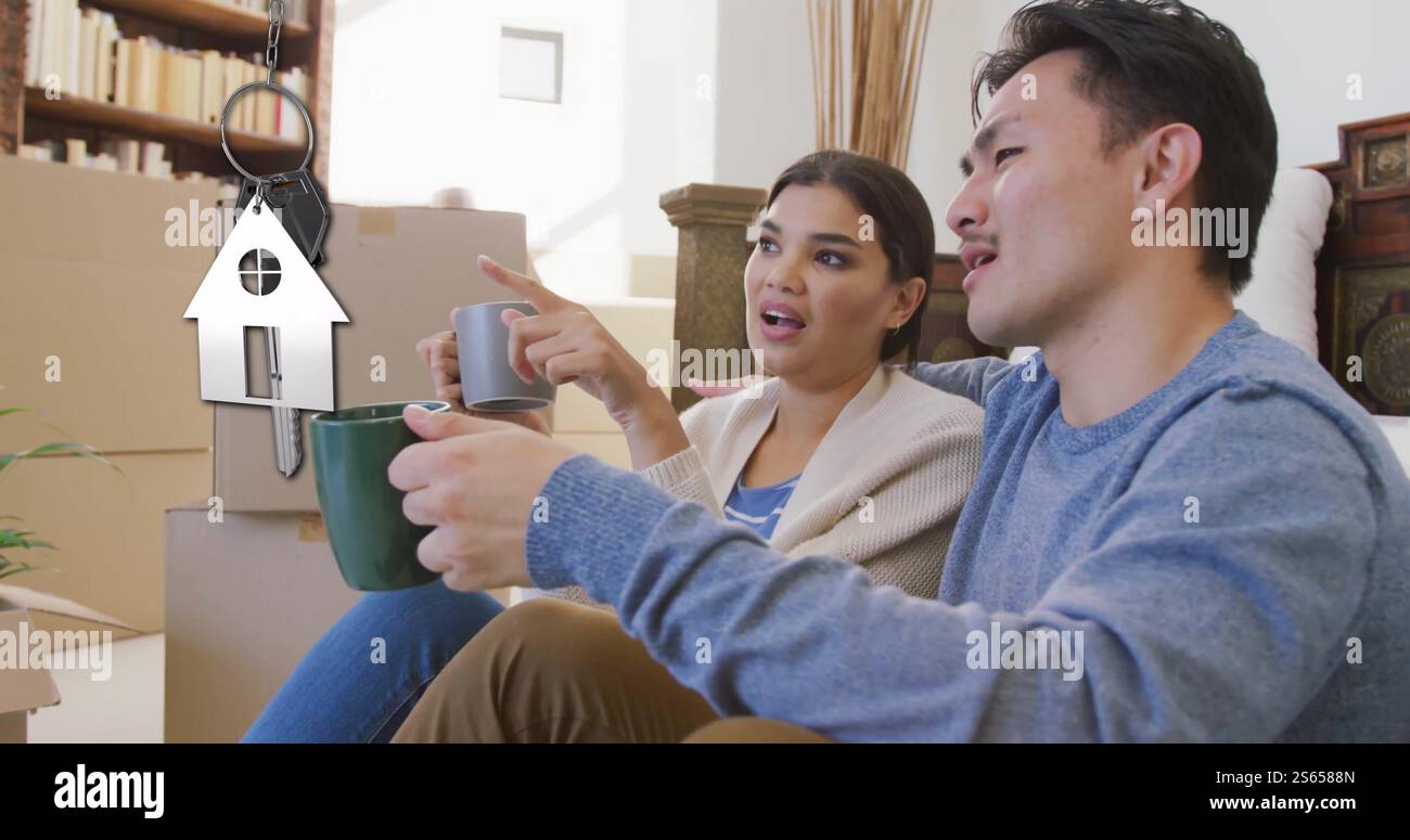 Image of silver house key and key fob over happy biracial couple by cardboard boxes Stock Photo ...
