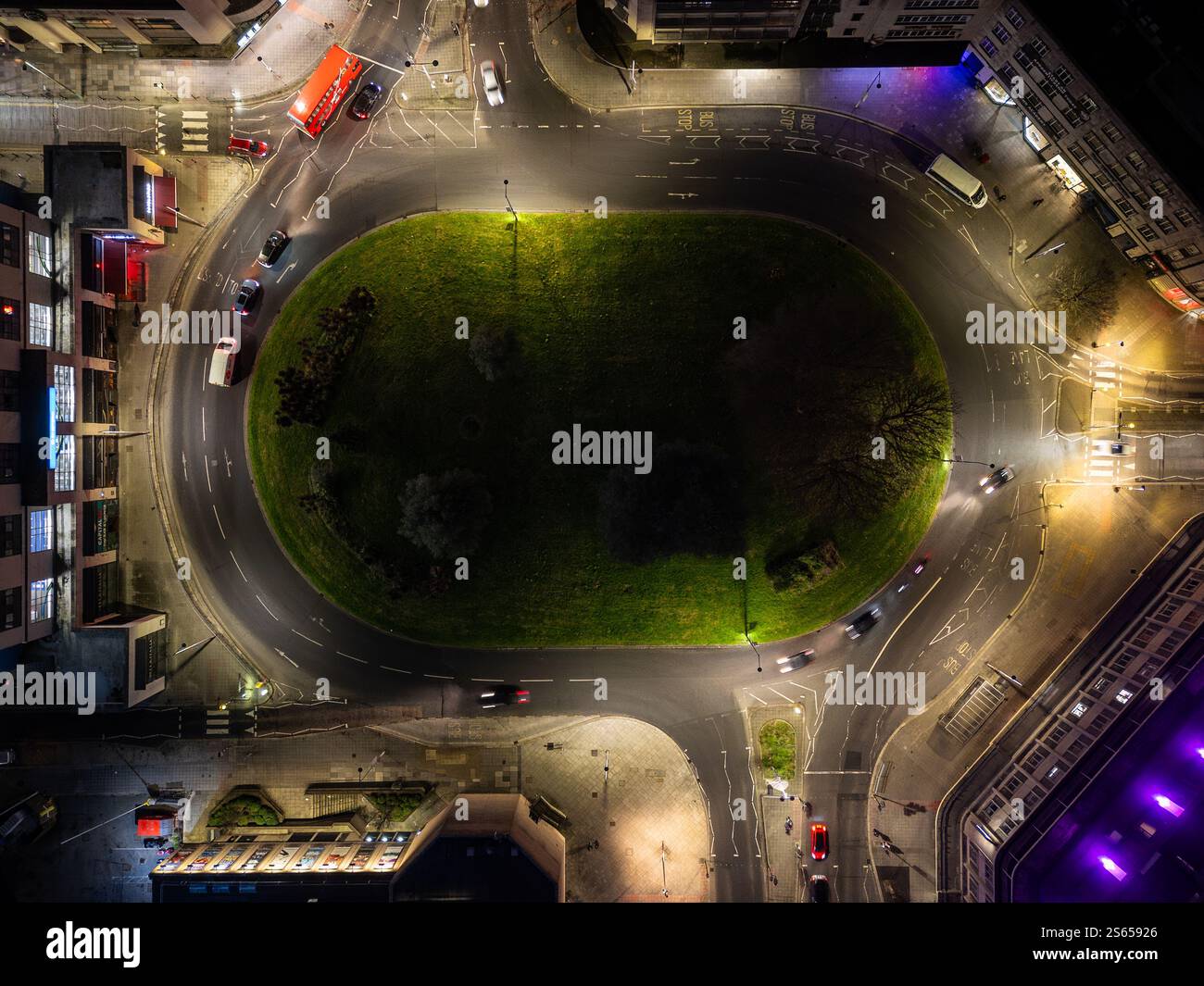 Aerial view of Charles Cross roundabout in Plymouth, Devon, at night, with cars driving around ...