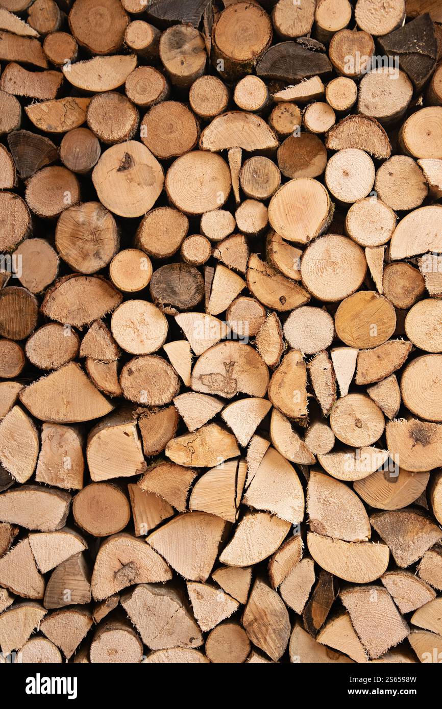 Split and stacked firewood in portrait format Stock Photo - Alamy