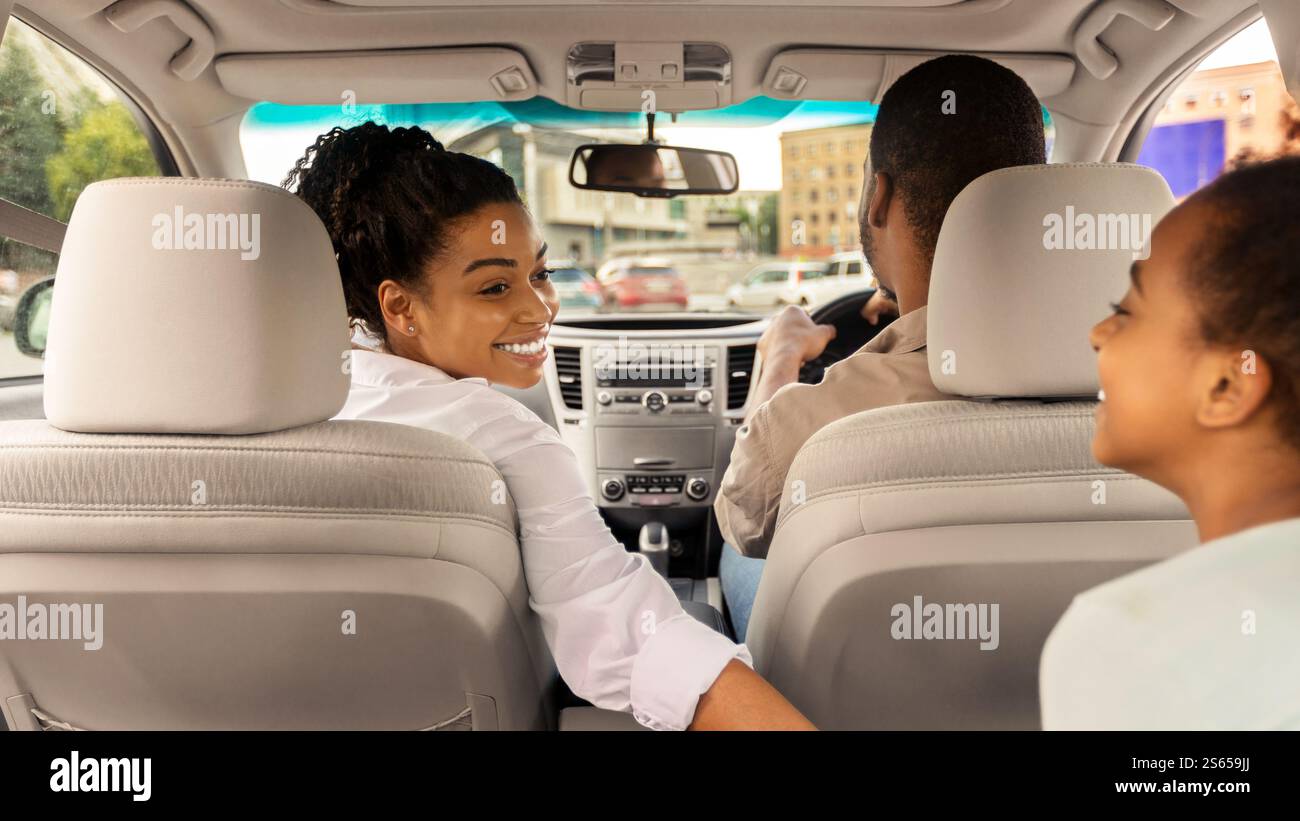 Back View Of African Family Riding Car In Urban Area Stock Photo - Alamy