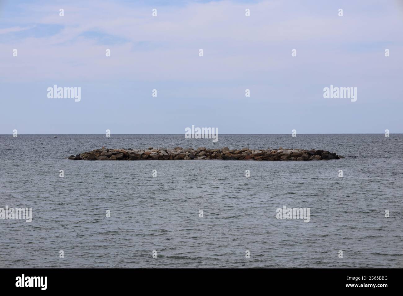 rocky manmade atoll island surrounded by sea Stock Photo - Alamy