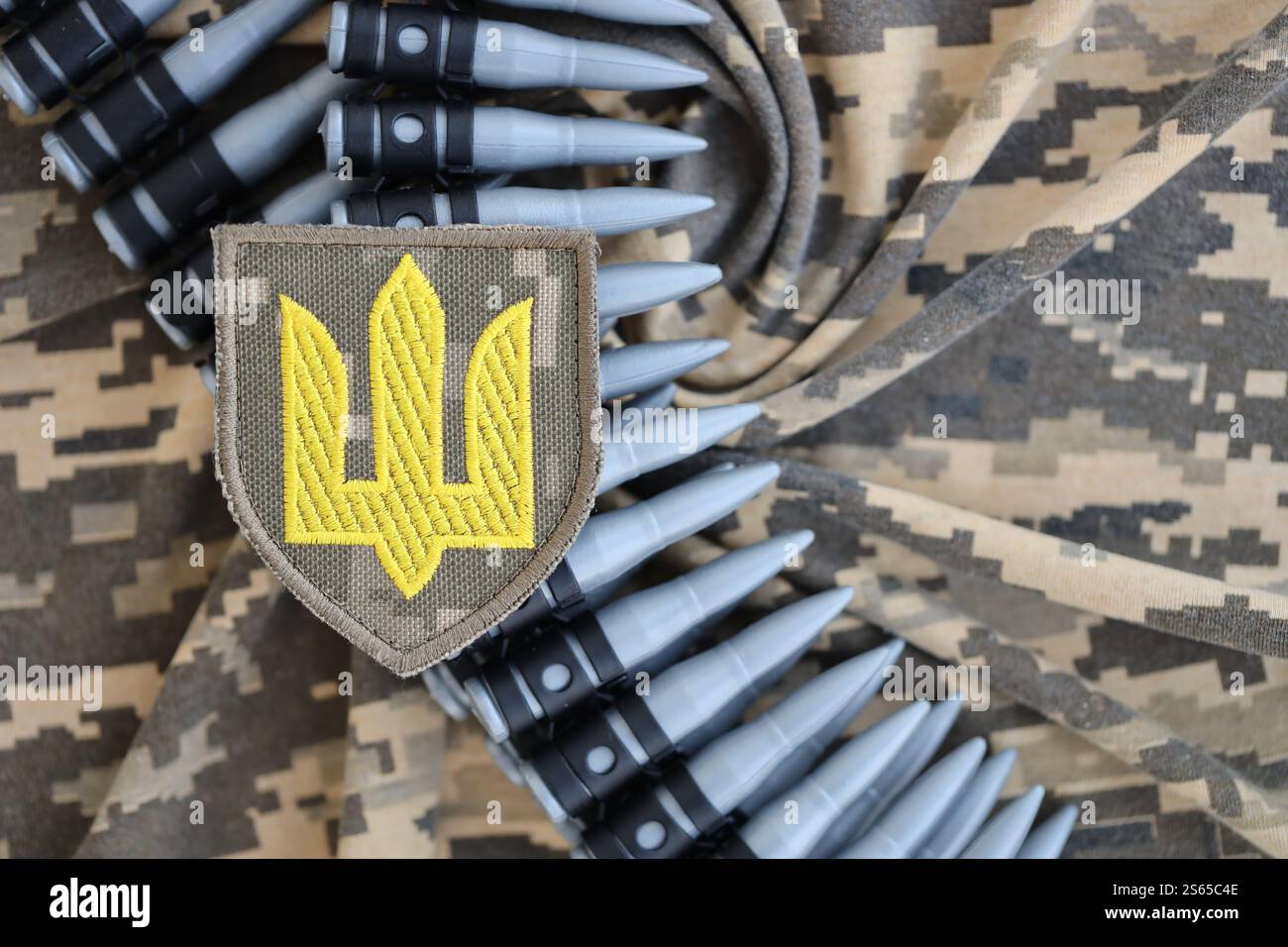 Ukrainian army symbol on machine gun belt lies on ukrainian pixeled ...