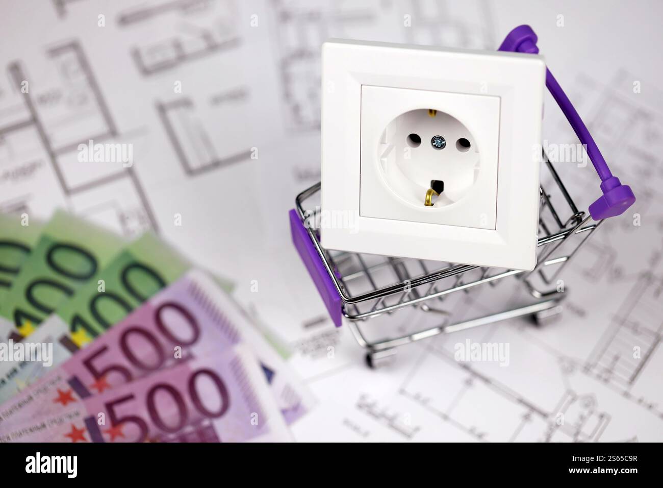 European standard EU outlet in small shopping cart on blueprints of ...