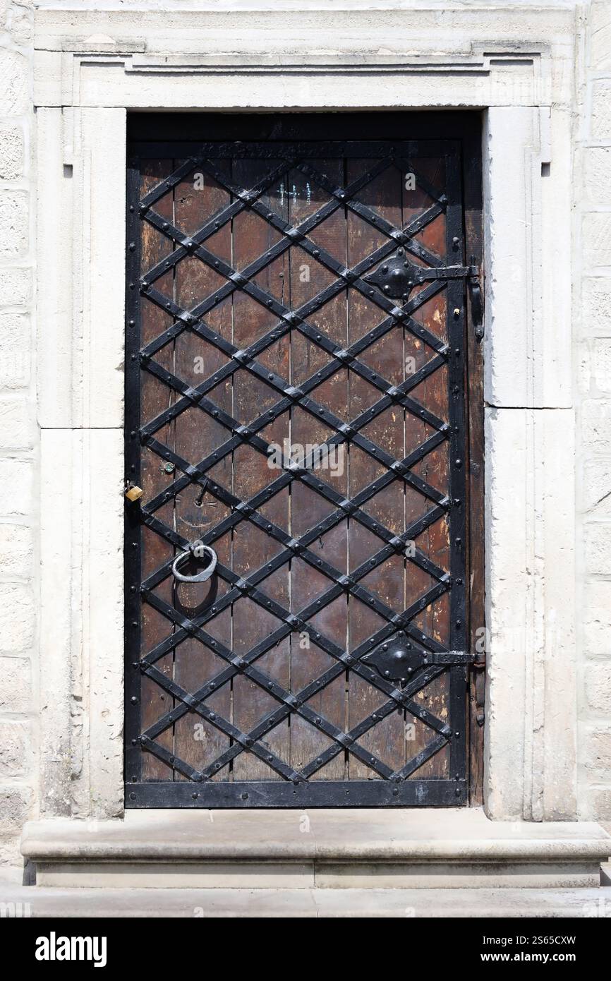 Very old solid door in brick stone wall of castle or fortress of 18th ...
