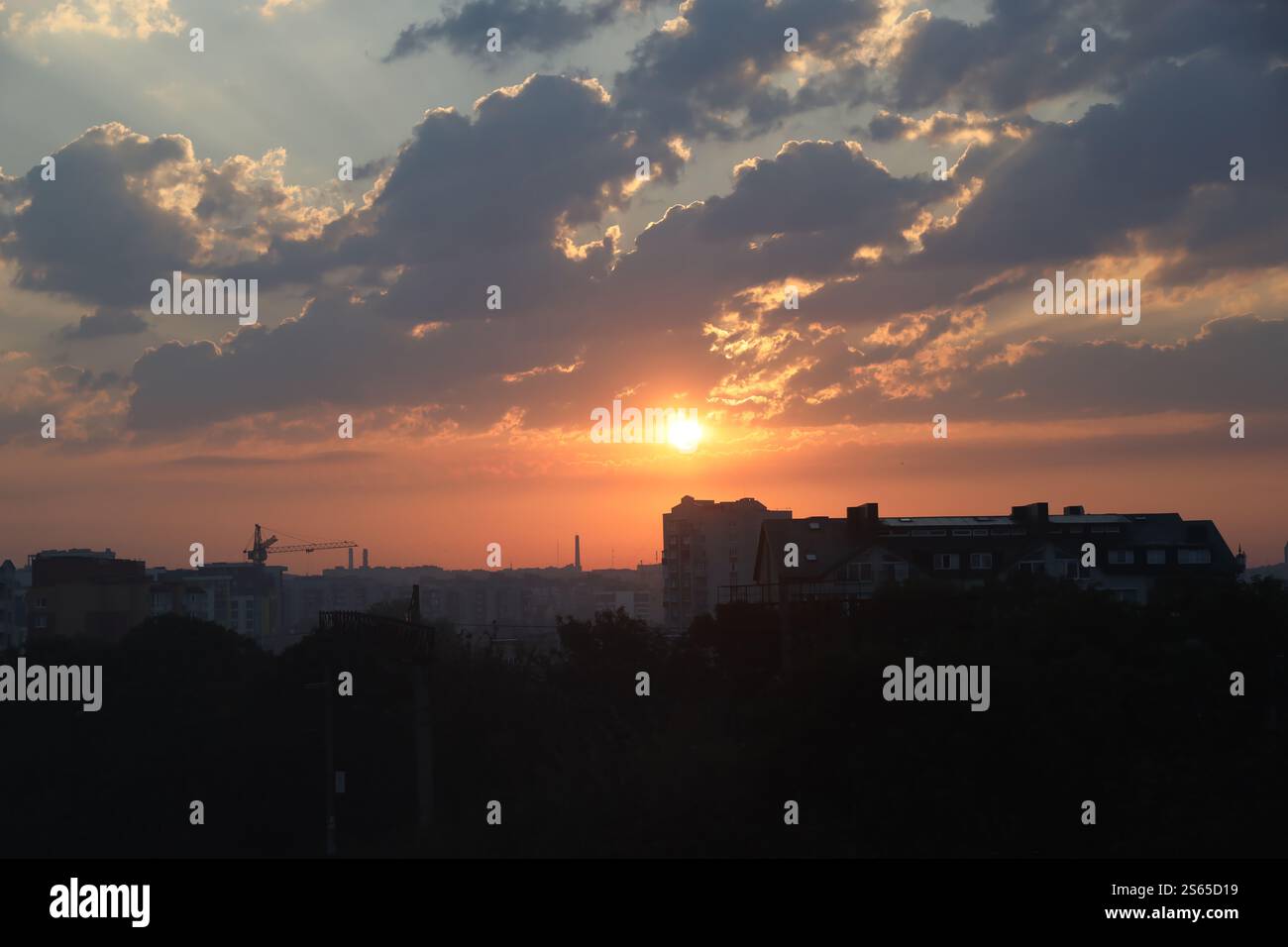 Beautiful sunrise with warm orange sunlight and beams through cloudy ...