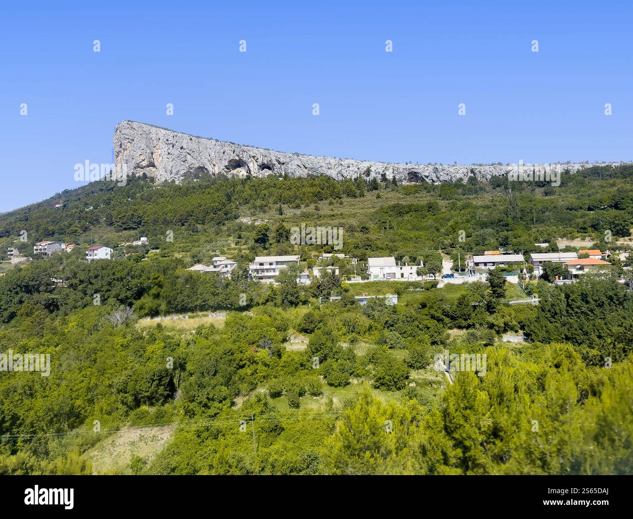 Split, Croatia - July 1, 2024: Long gray cliff mountain wall NE of Klis ...