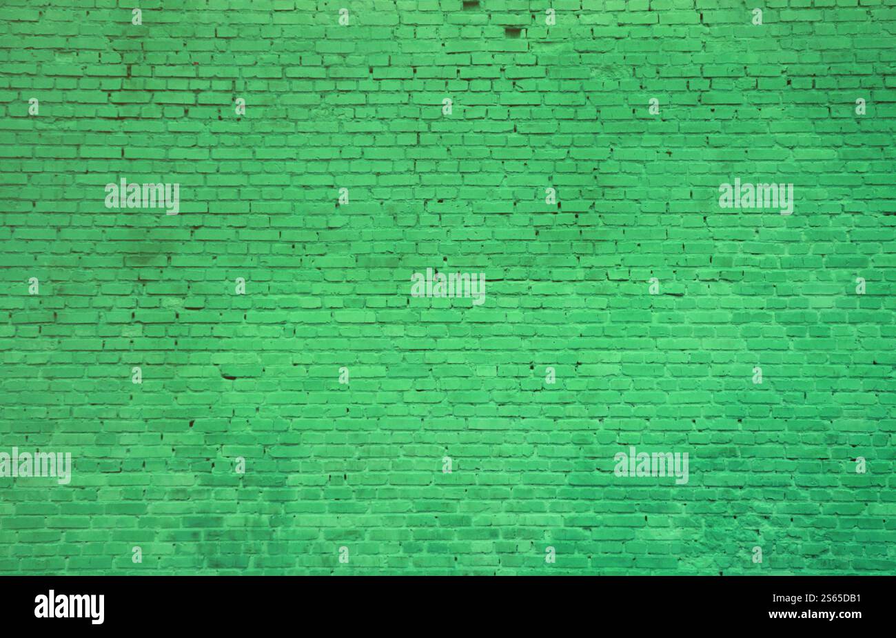 The texture of the brick wall of many rows of bricks painted in green ...