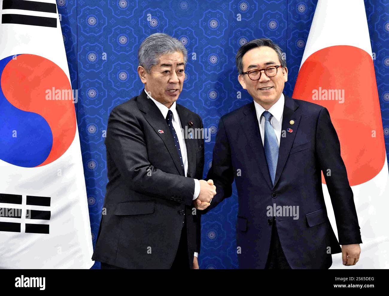South Korean Minister of Foreign Affairs Cho Tae-yul (R) shakes hands ...