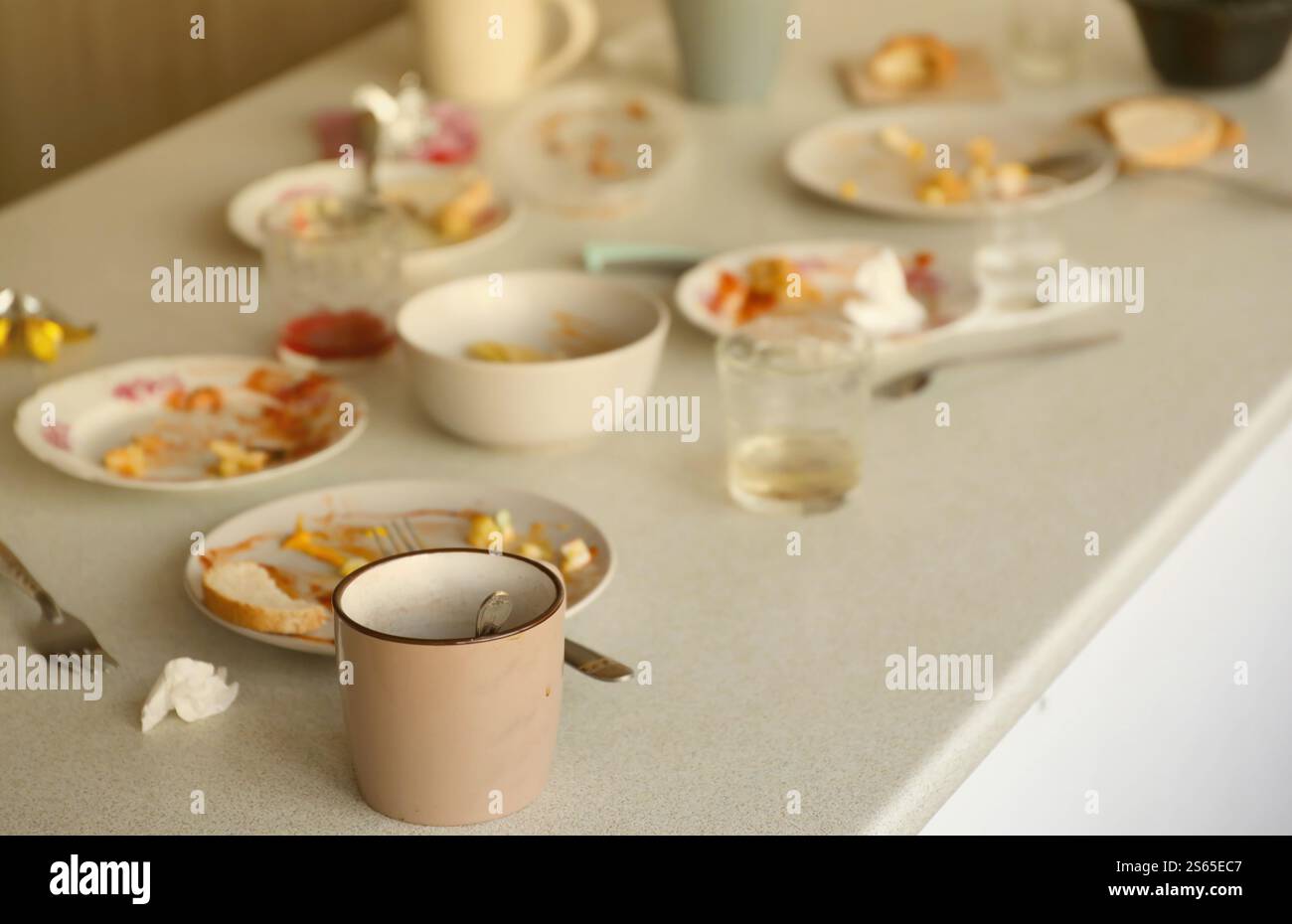 Empty dirty plates with spoons and forks on the table after meal ...