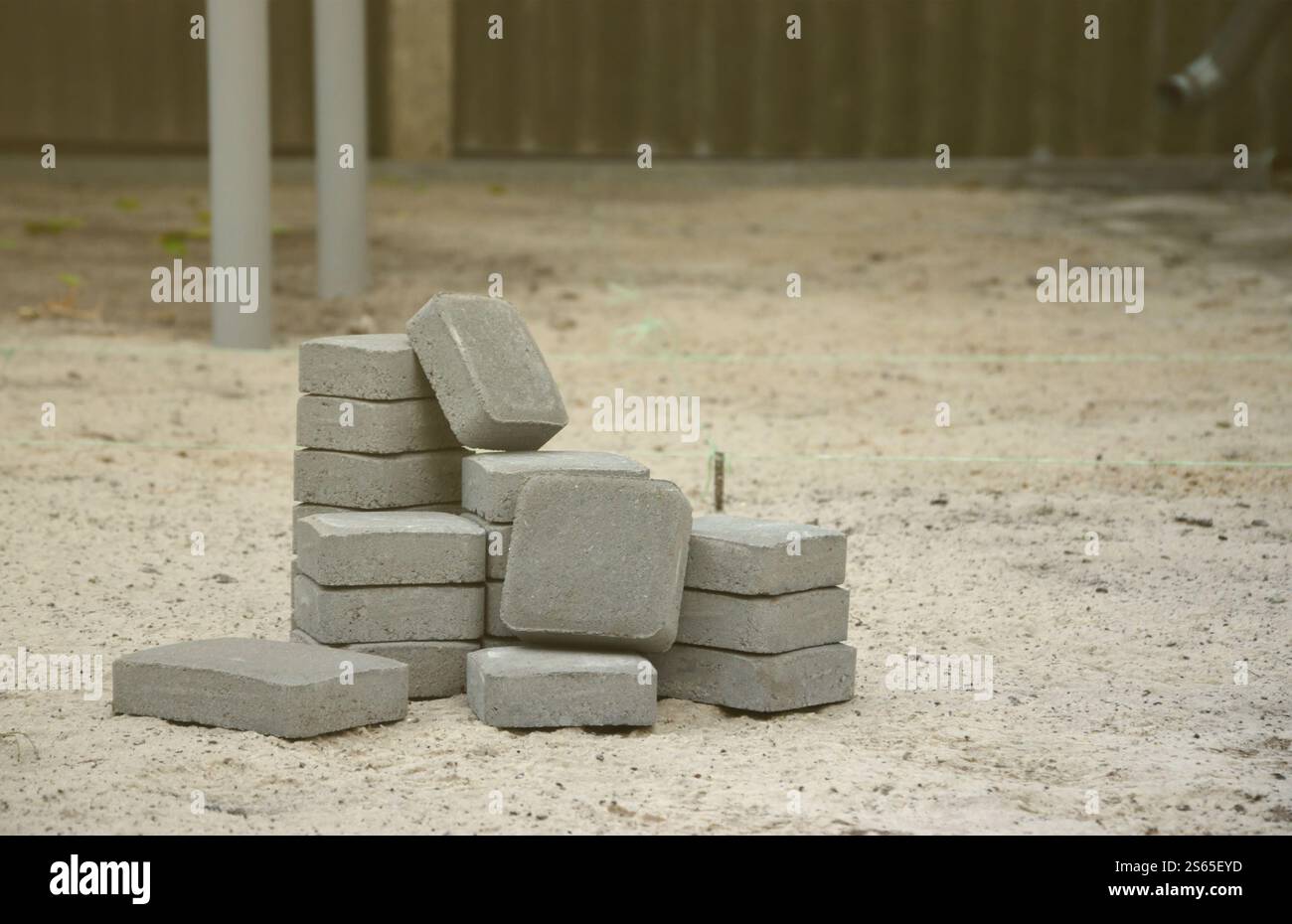 Small pile of gray walkway slabs lying in stack outdoors. Material for ...