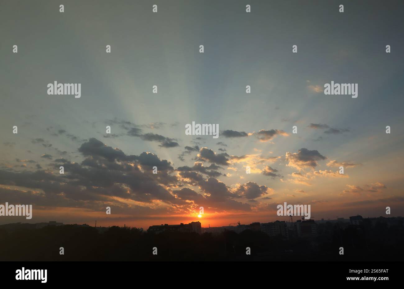 Beautiful sunrise with warm orange sunlight and beams through cloudy ...