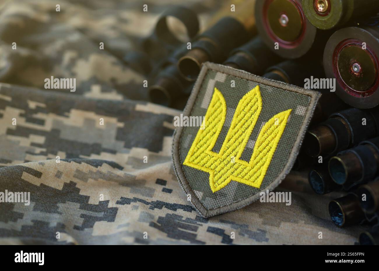 Ukrainian army symbol on machine gun belt lies on ukrainian pixeled ...