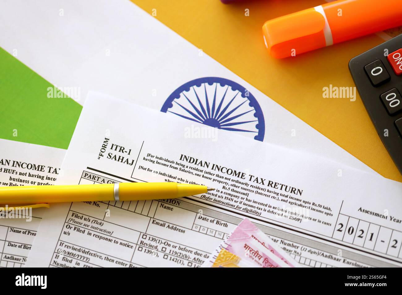 Indian income tax return blank form with pen and indian rupees bills on ...