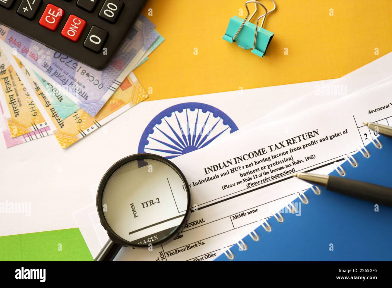 Indian income tax return blank form with pen and indian rupees bills on ...