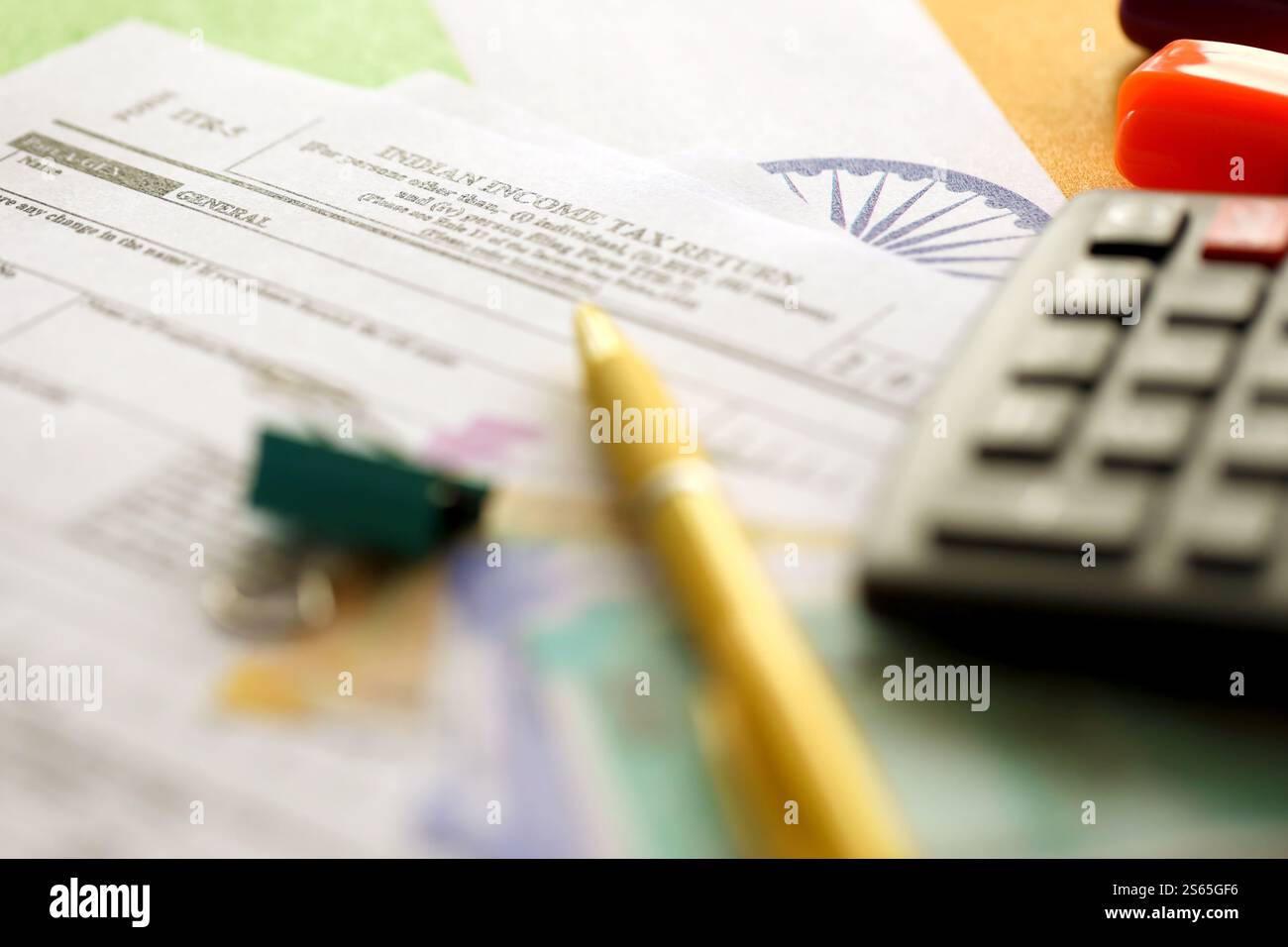 Indian income tax return blank form with pen and indian rupees bills on ...