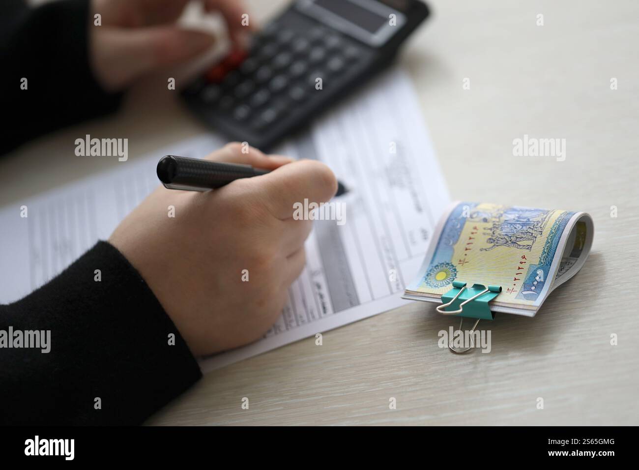 Accountant start to fill Iranian tax form on office table. Taxation ...