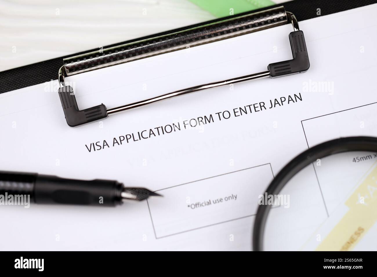 Visa application to enter Japan on A4 tablet lies on office table with ...