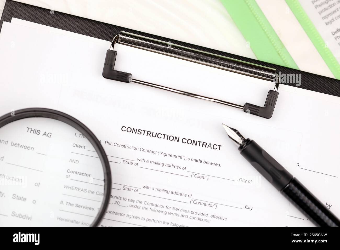 Construction contract form on A4 tablet lies on office table with pen ...
