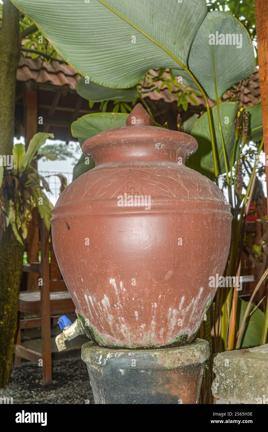 a jug with a faucet for washing hands in a traditional Javanese ...