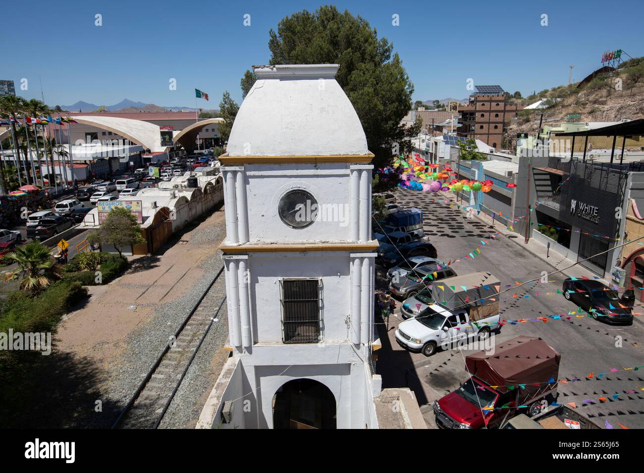 Colorful papel picado frames the historic clock tower of the downtown ...