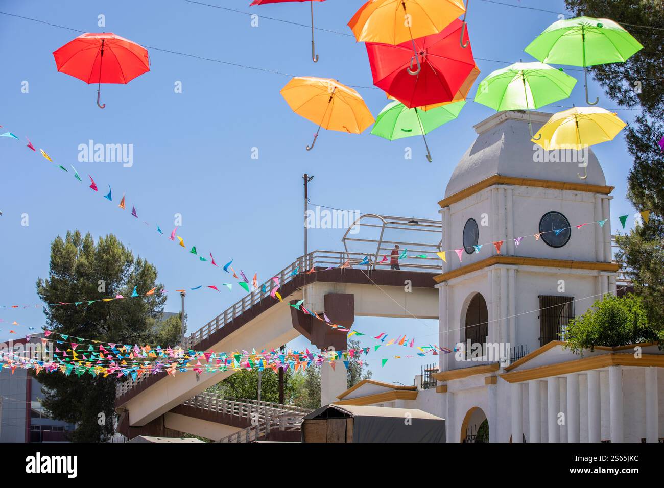 Colorful papel picado frames the historic clock tower of the downtown ...