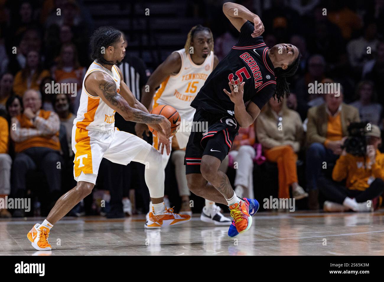 Georgia guard Silas Demary Jr. (5) falls back as he collides with ...