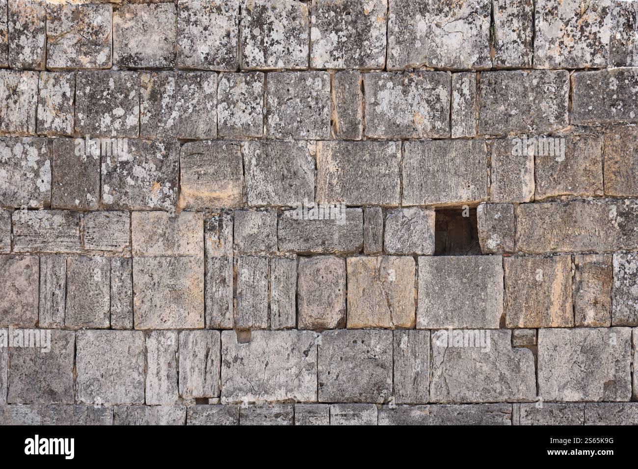 Texture of a stone wall with many big brown and grey stones armed with ...