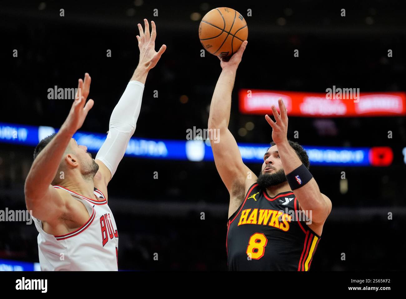 Chicago Bulls center Nikola Vucevic (9), left, tries to block Atlanta ...