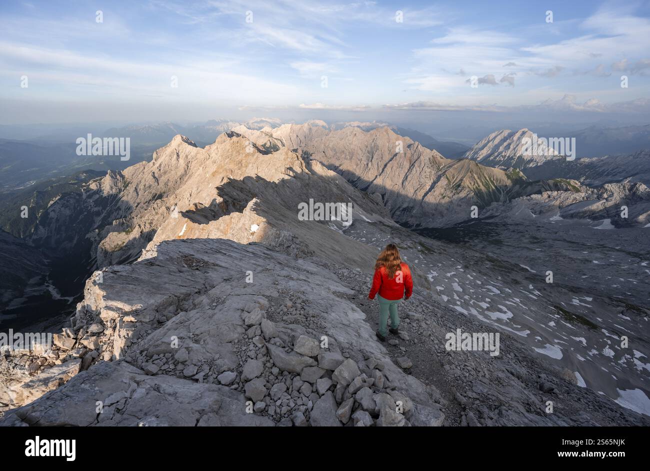 Mountaineer on a steep rocky ridge, impressive mountain landscape, view ...