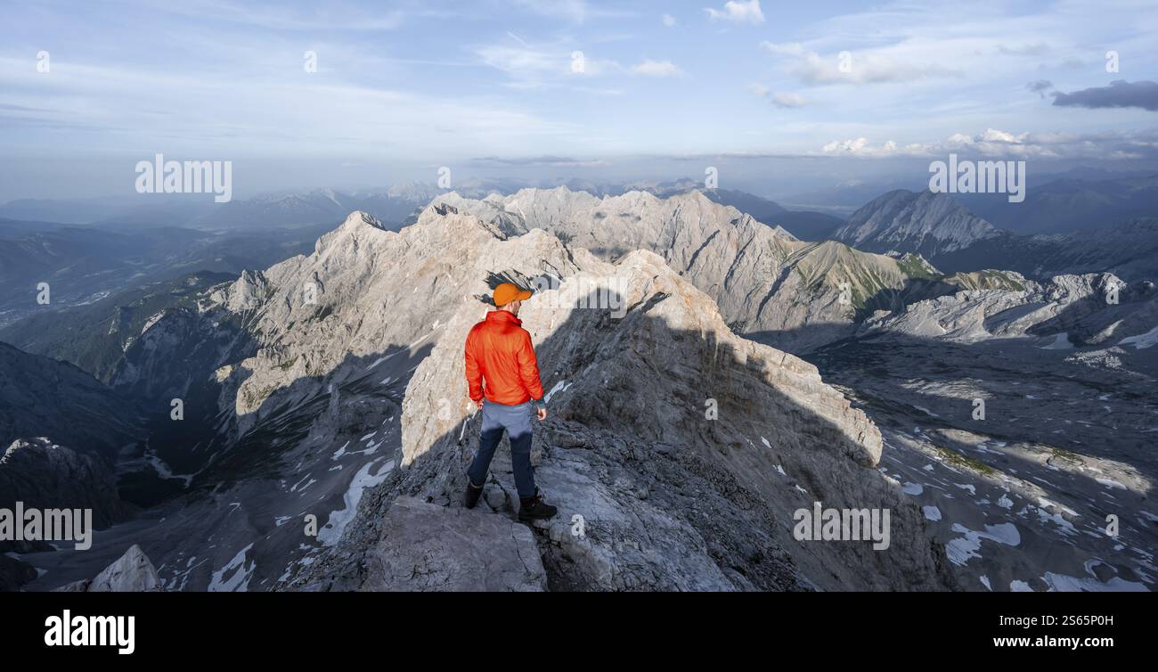 Mountaineer on a narrow rocky steep ridge, view of the Hoellental and ...