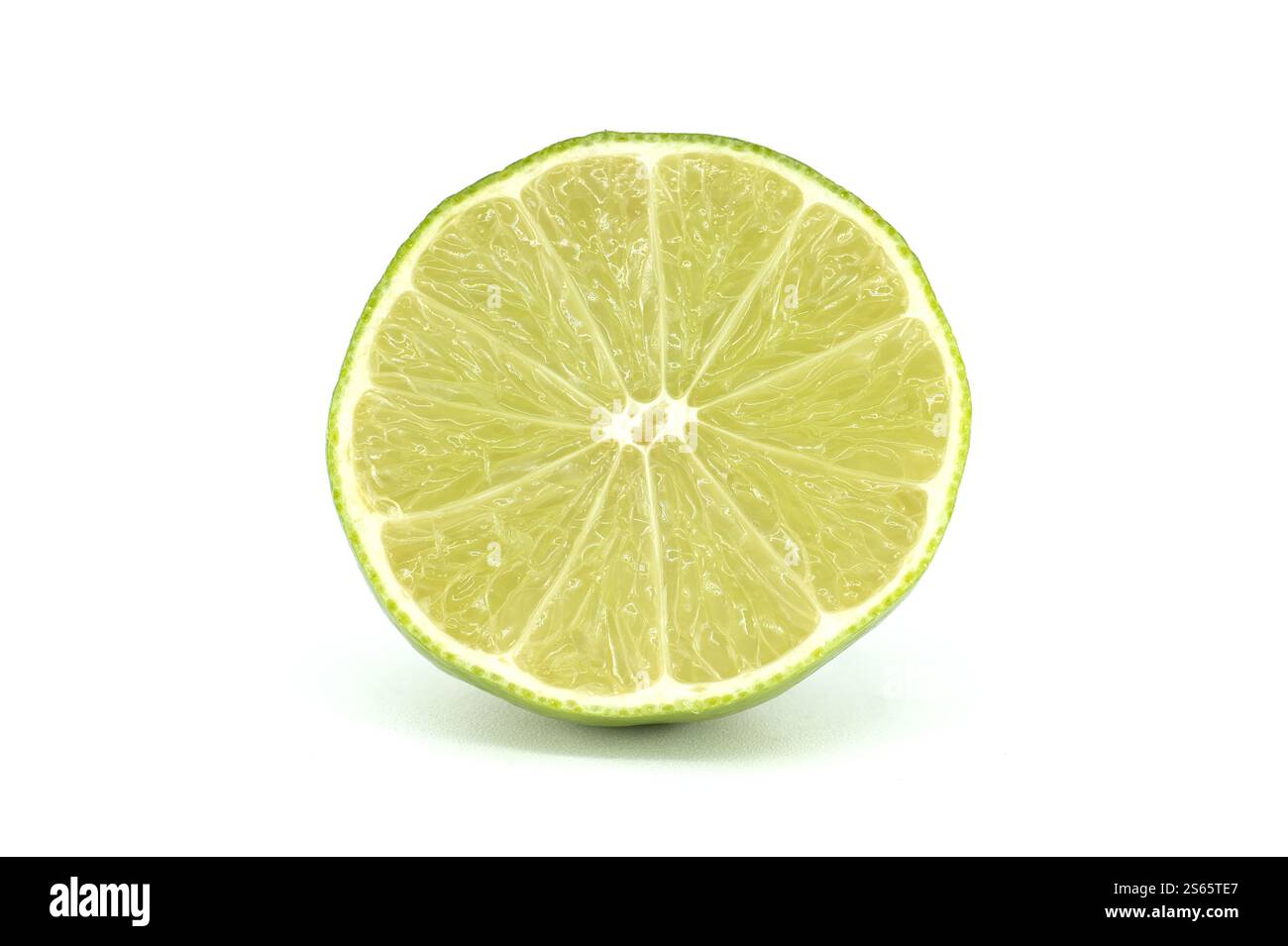 Lime fruit cut in half revealing its juicy texture, segments, and ...