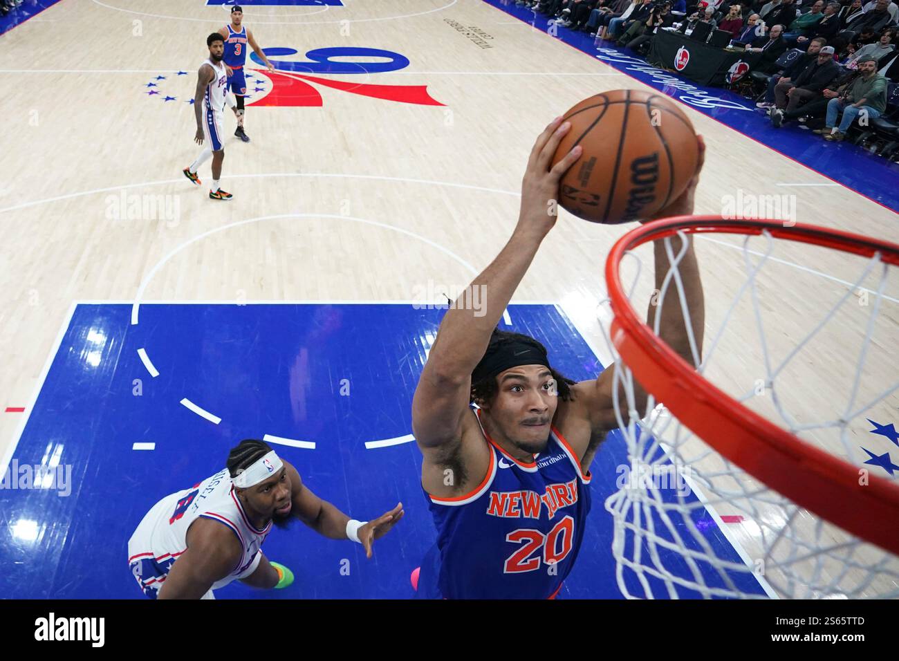 New York Knicks' Jericho Sims, right, goes up for a dunk past ...
