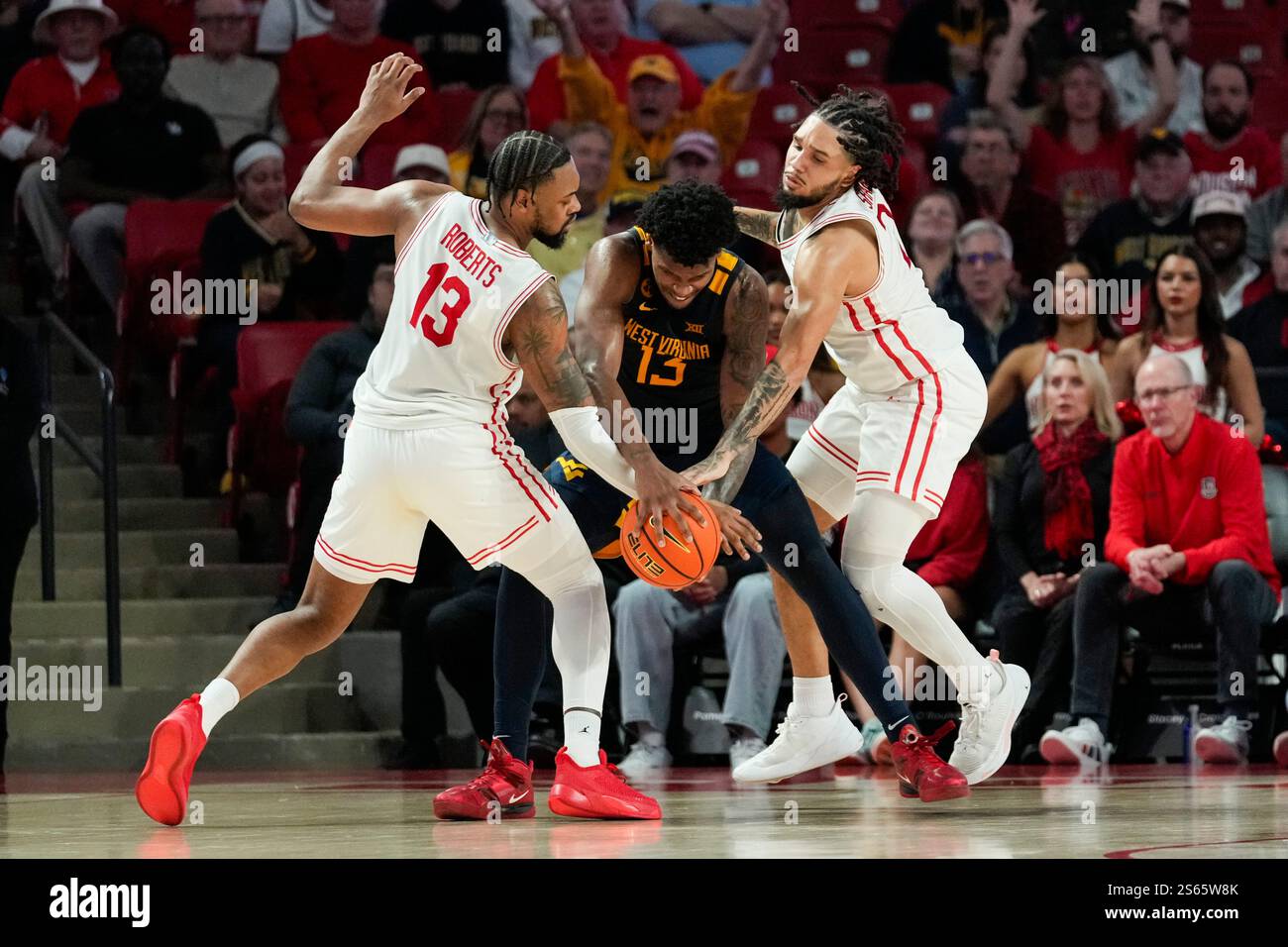 Houston forward J'Wan Roberts (13) and guard Emanuel Sharp, right ...