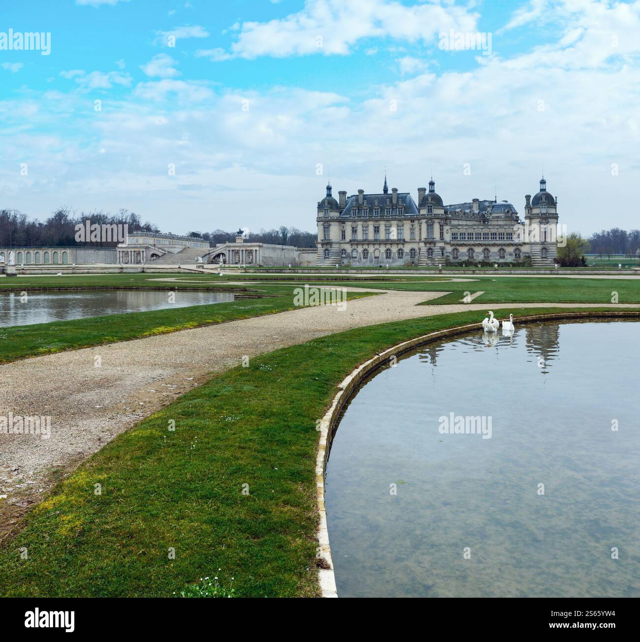 The Chateau de Chantilly (France) and swans in pond. The Grand Chateau ...